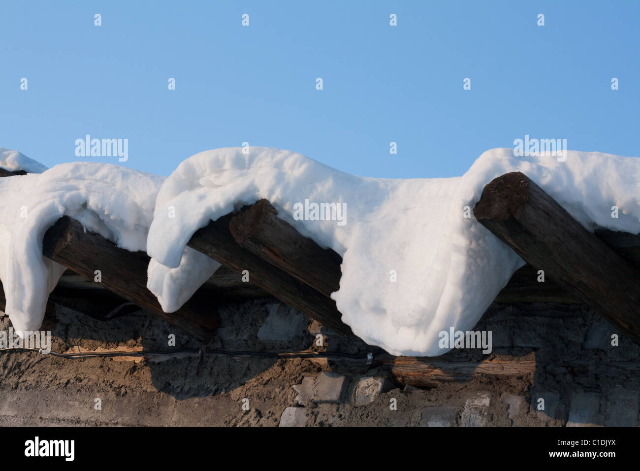 Wooden roof, drooping snow, winter, sunny, blue sky Stock Photo - Alamy