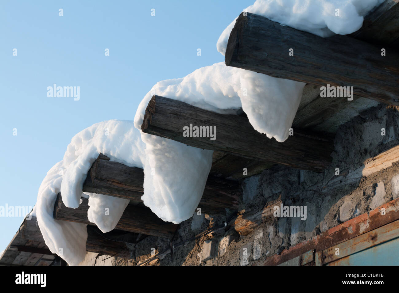 Wooden roof, drooping snow, winter, sunny, blue sky Stock Photo - Alamy