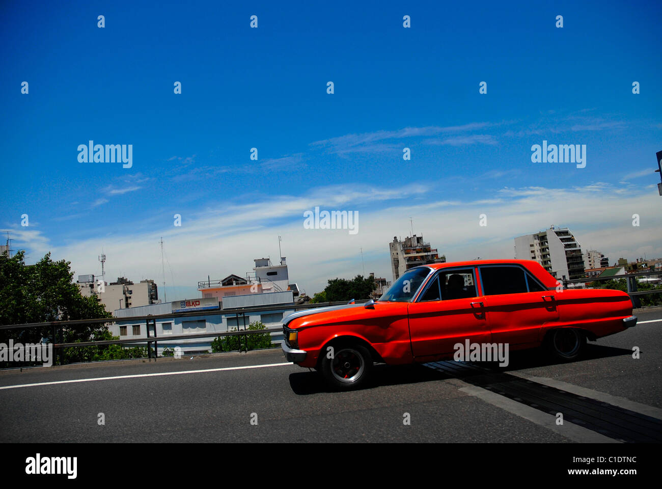 red car driving along Stock Photo - Alamy