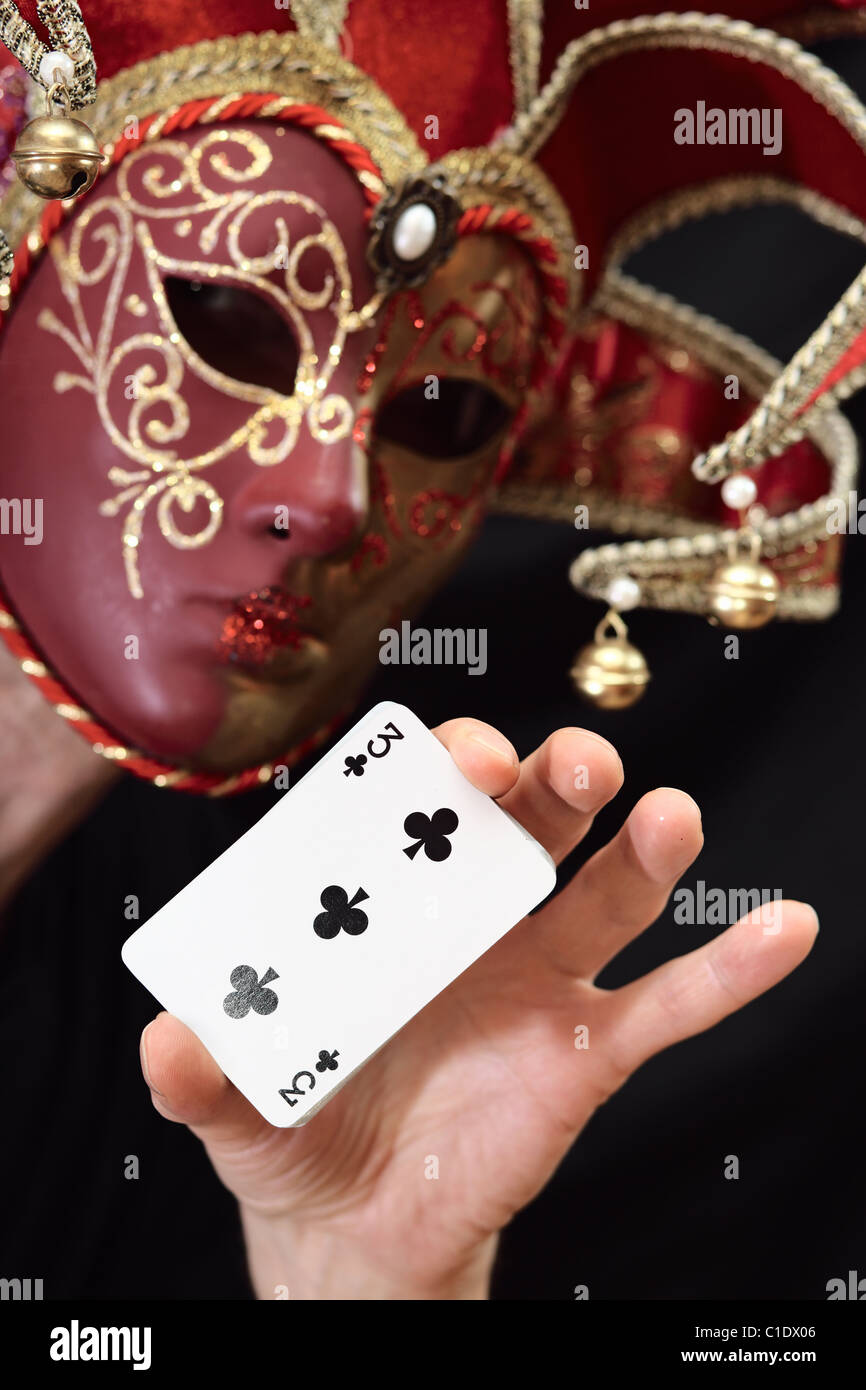 The person in a mask with cards Stock Photo - Alamy