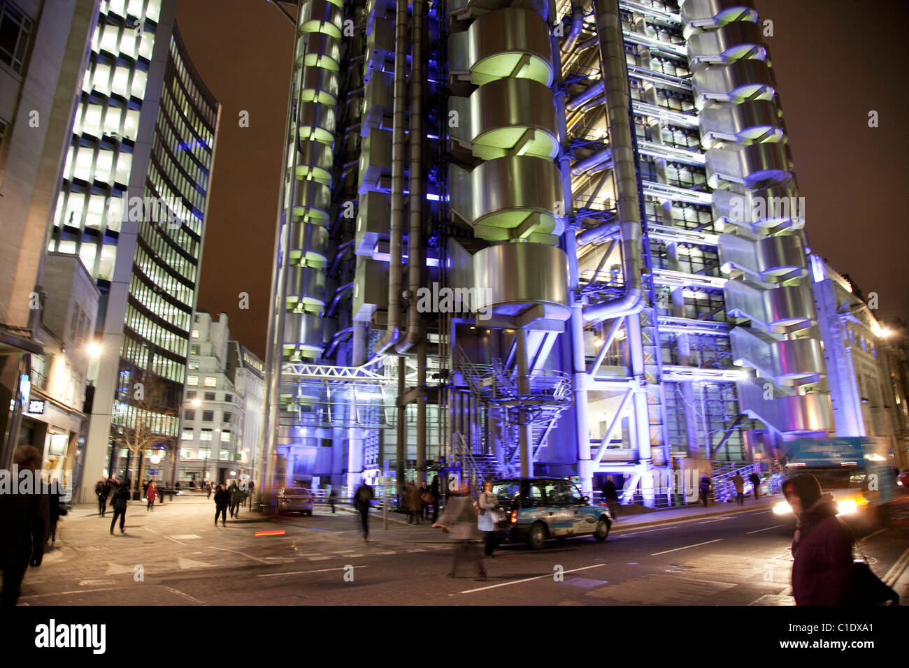 Night time scene in the City of London. The Lloyds building lit up with ...