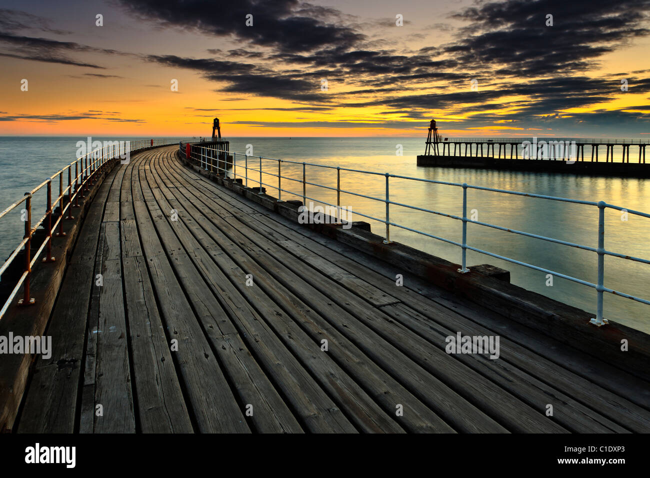 Looking down the boardwalk towards the end of Whitby Pier Stock Photo ...