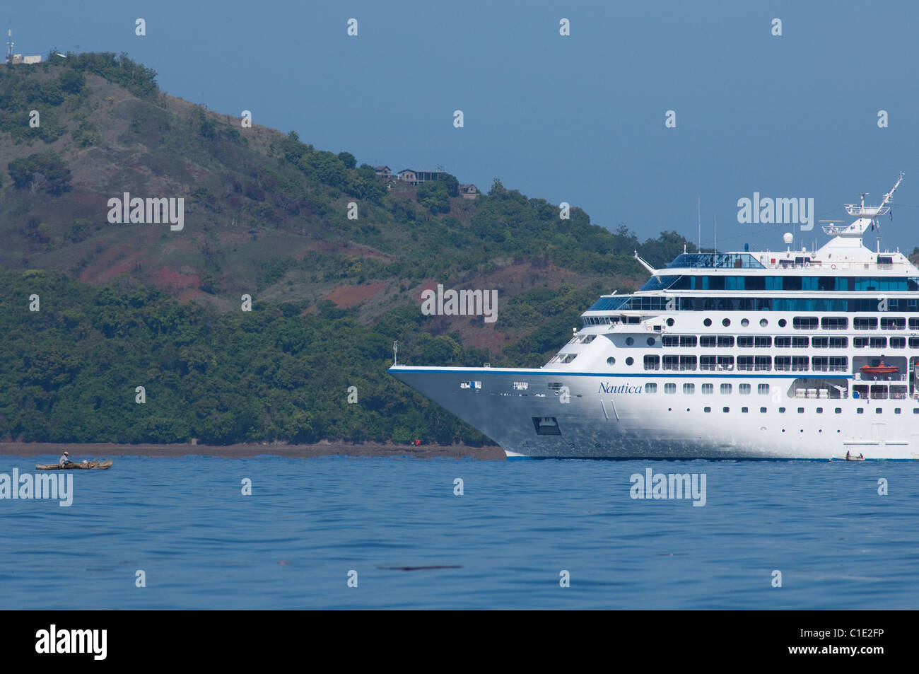 Madagascar, Island of Nosy Be. Oceania cruise ship, Nautica, with small ...