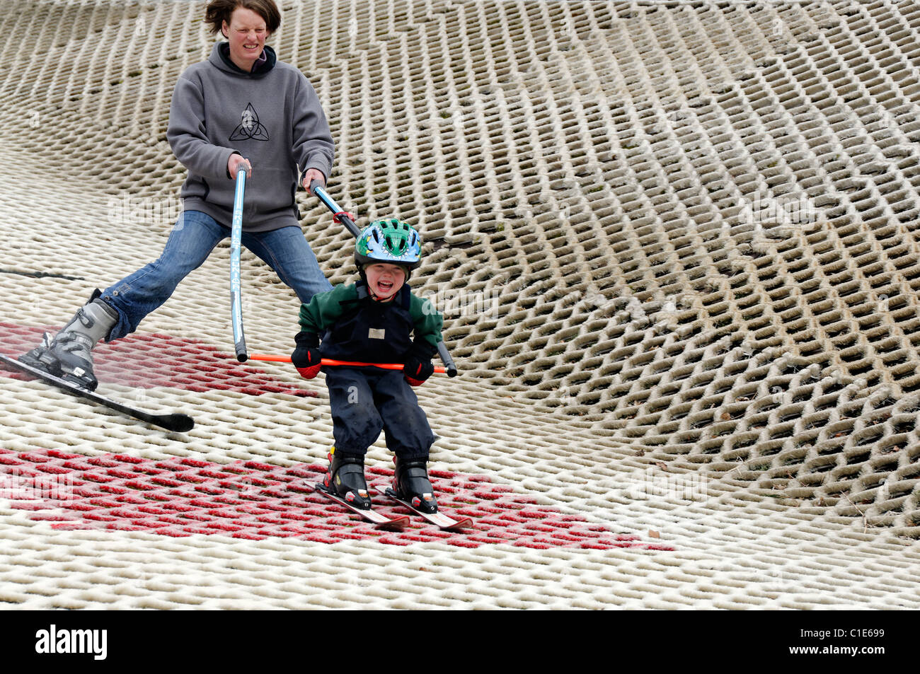 A young boy learning to ski on a dry ski slope Stock Photo - Alamy