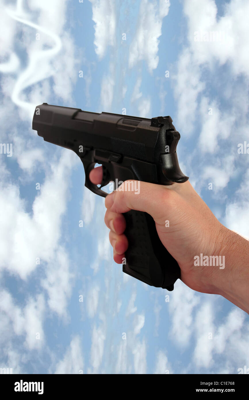 a gun being shot against a cloudy background with clipping path Stock ...
