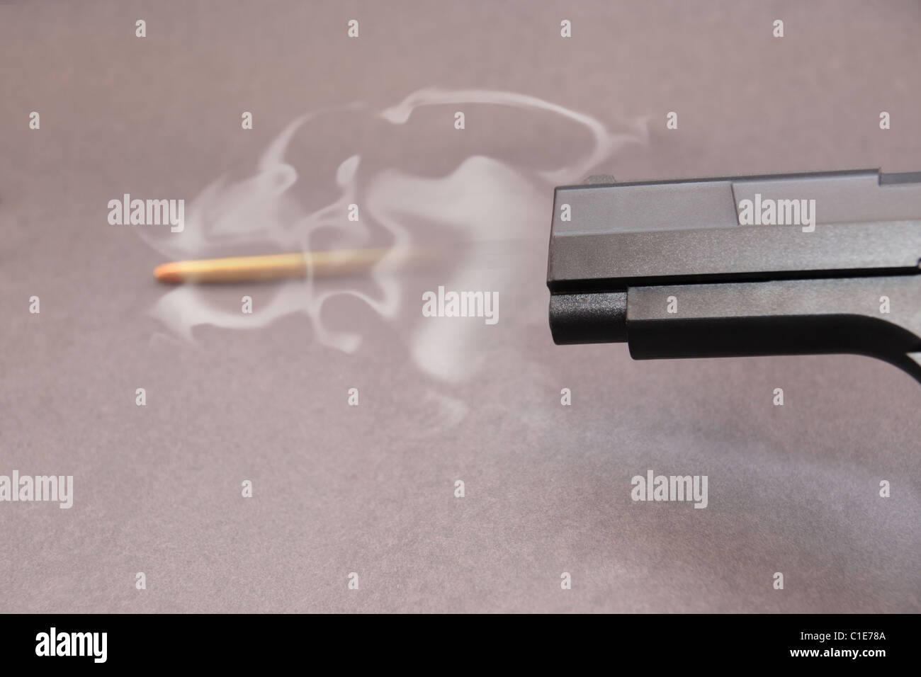 a gun being shot against a black background Stock Photo - Alamy