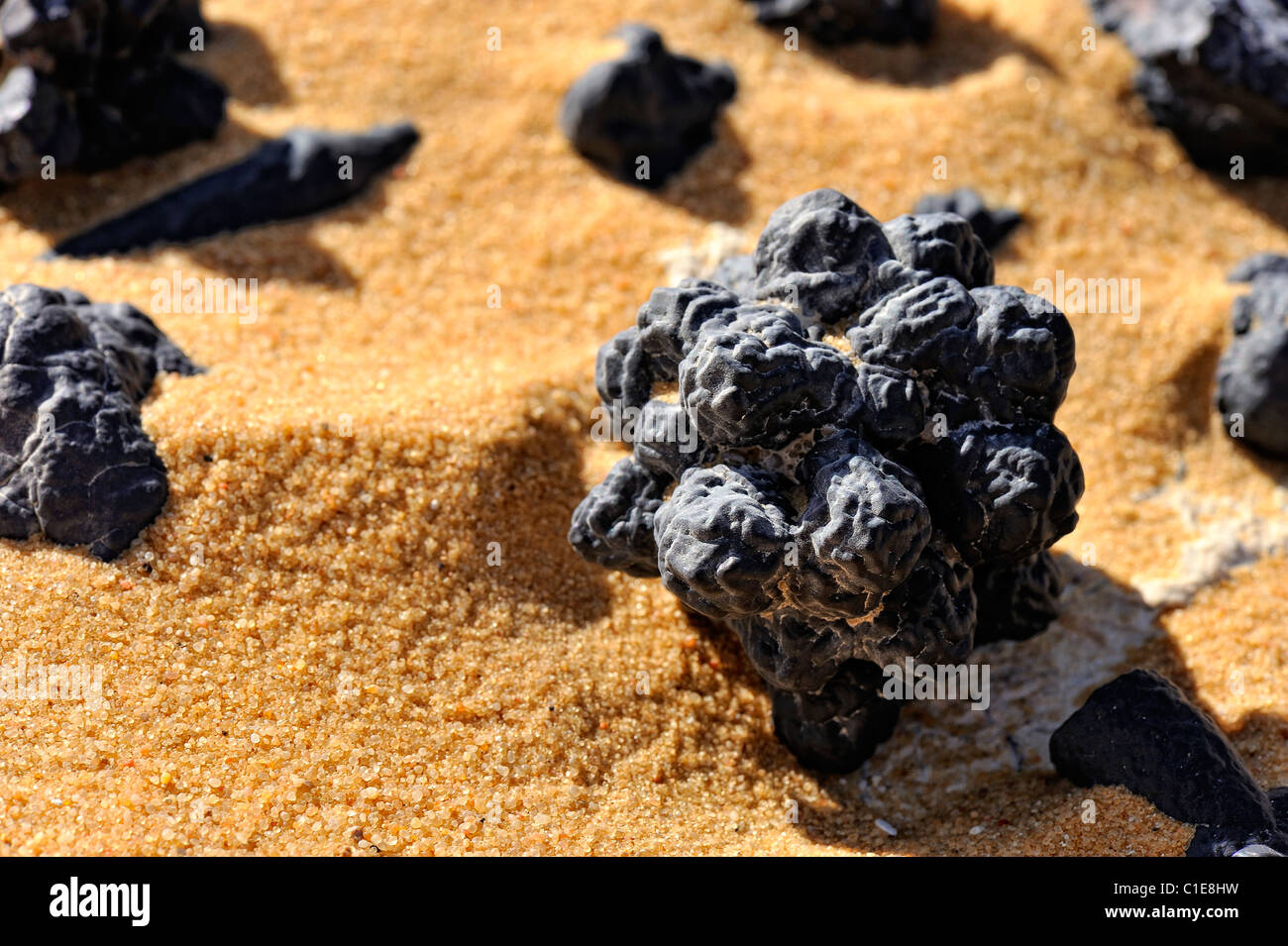 Small basalt black stones on sand in Crystal valley in the western ...