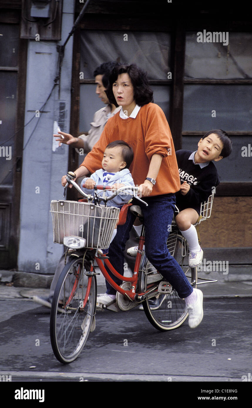 Japan, Honshu Island, Tokyo, woman and her children riding a bike Stock ...