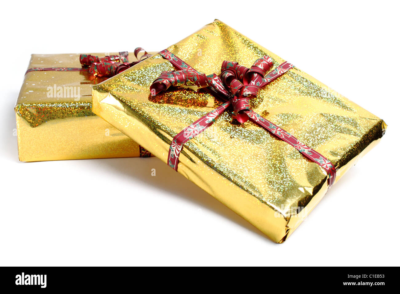 Two boxes in golden gift wrapping Stock Photo - Alamy