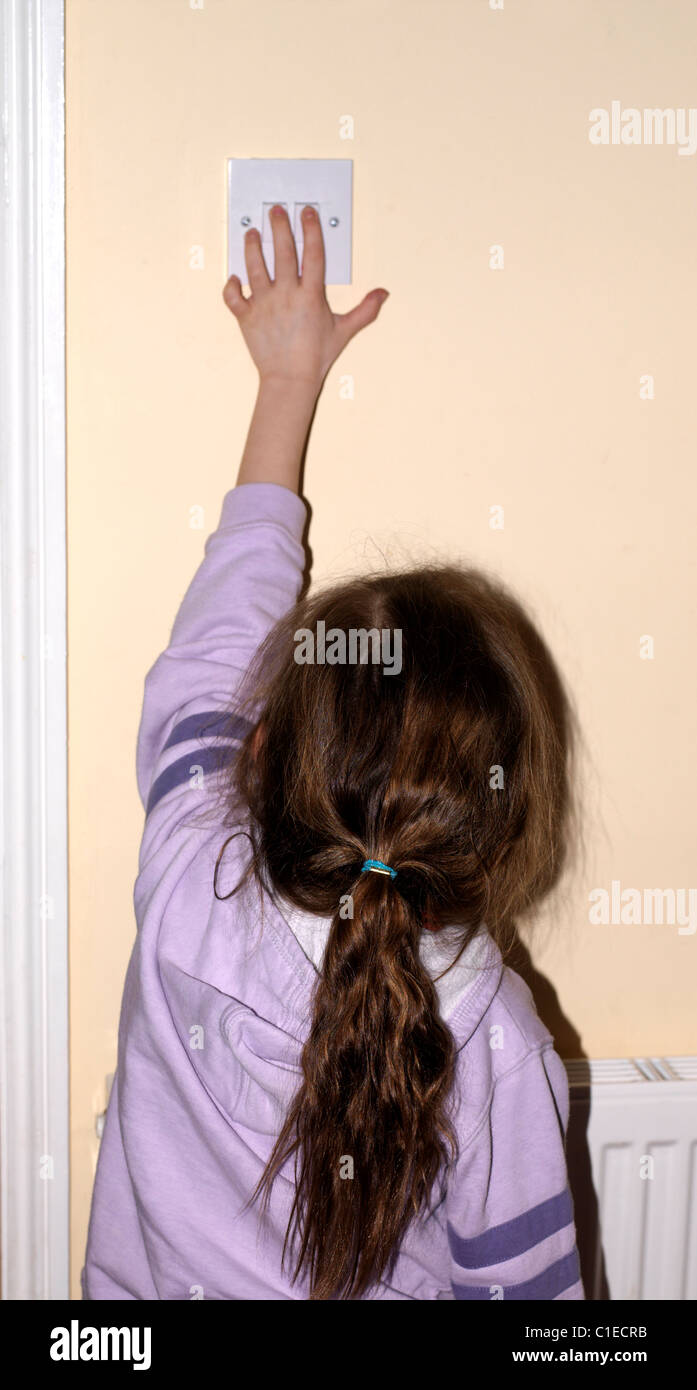 Child switching light off hi-res stock photography and images - Alamy