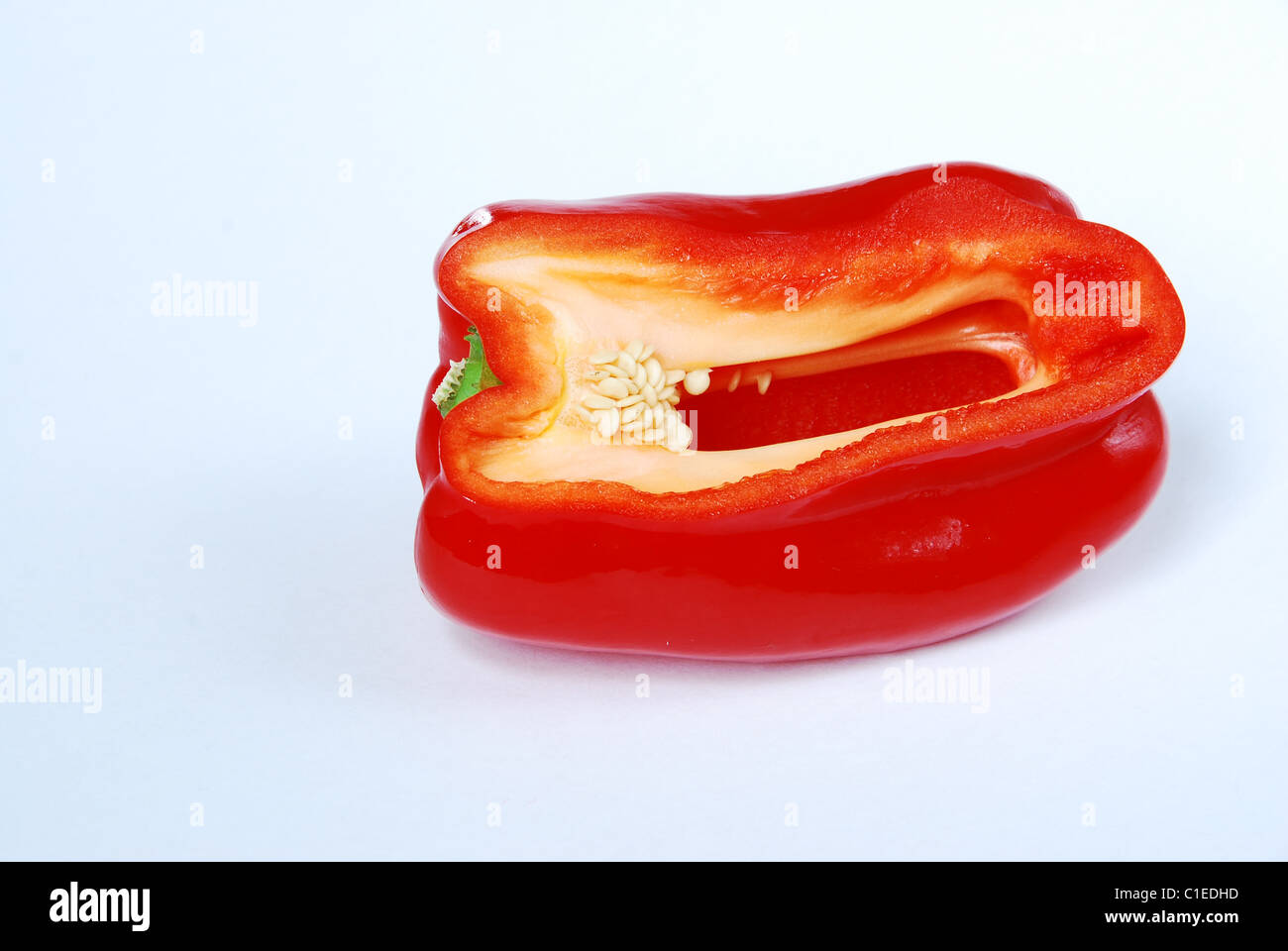Red bell pepper sliced showing seeds isolated on white background Stock ...