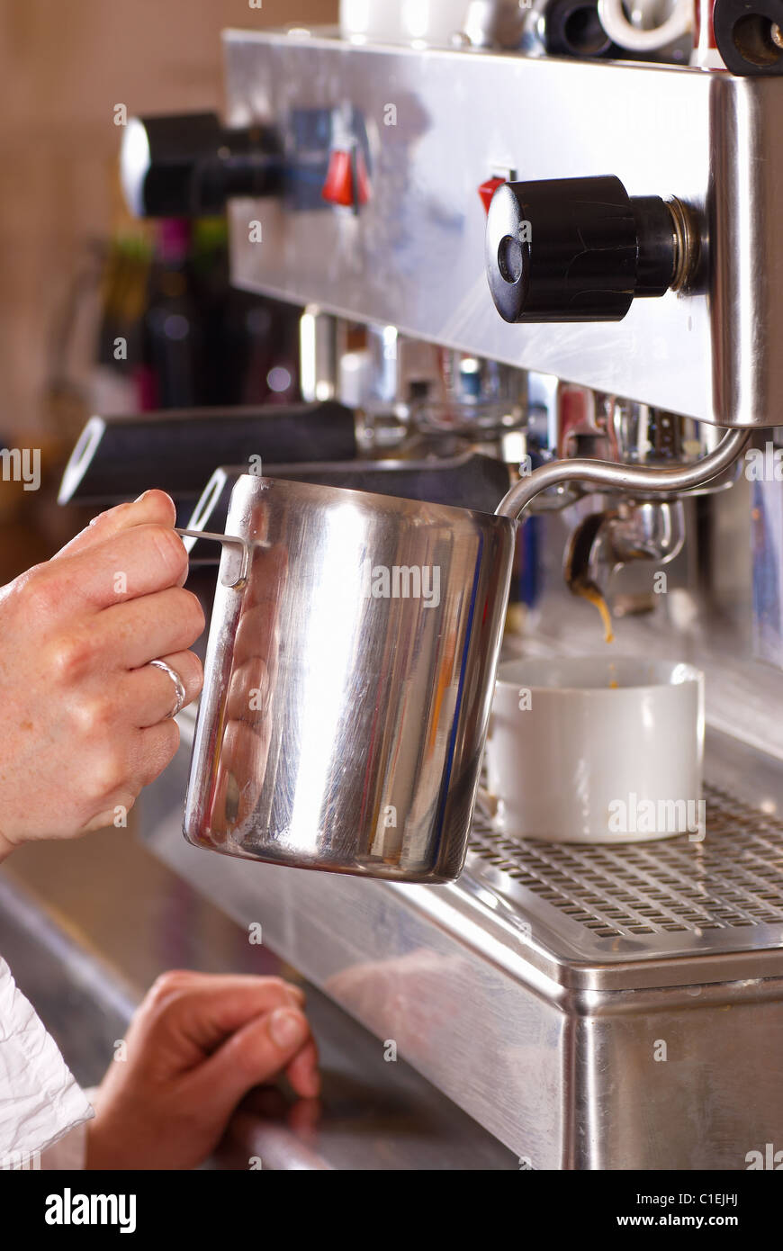 Operating a professional Italian coffee machine in a cafe Stock Photo ...