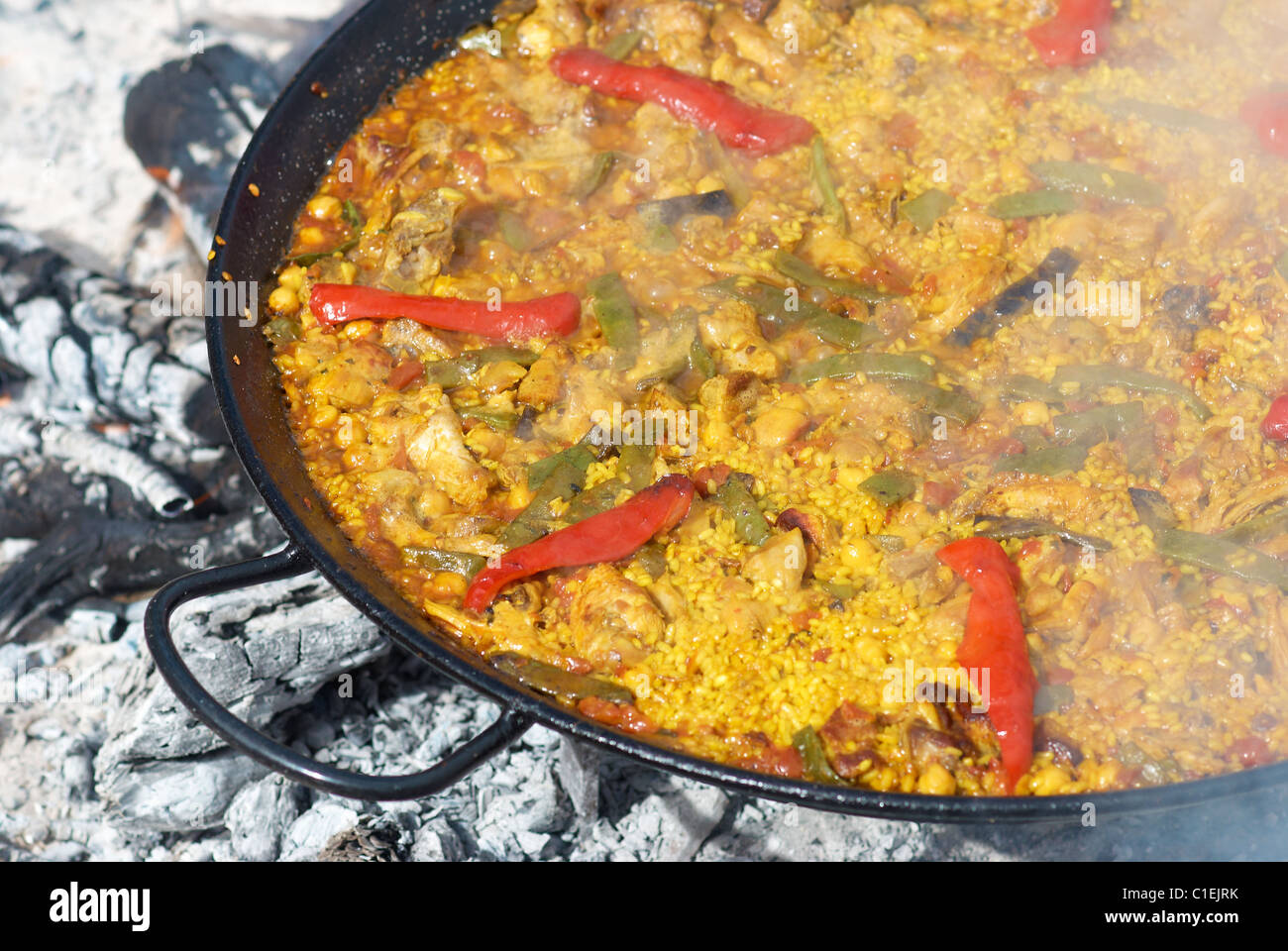 Spanish paella being cooked on an open fire Stock Photo - Alamy