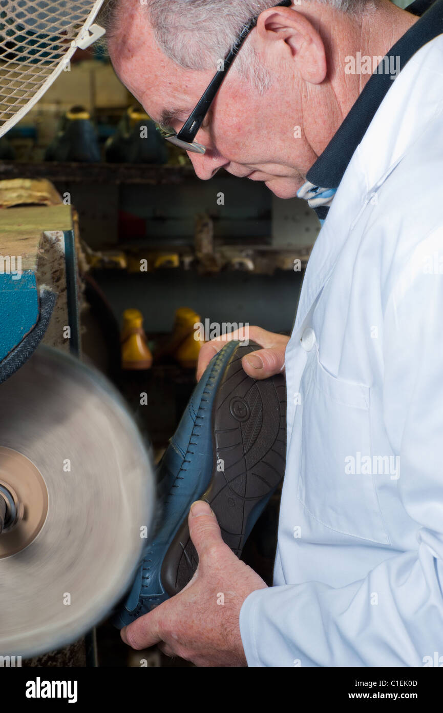 Experienced industrial worker in a footwear production plant Stock ...