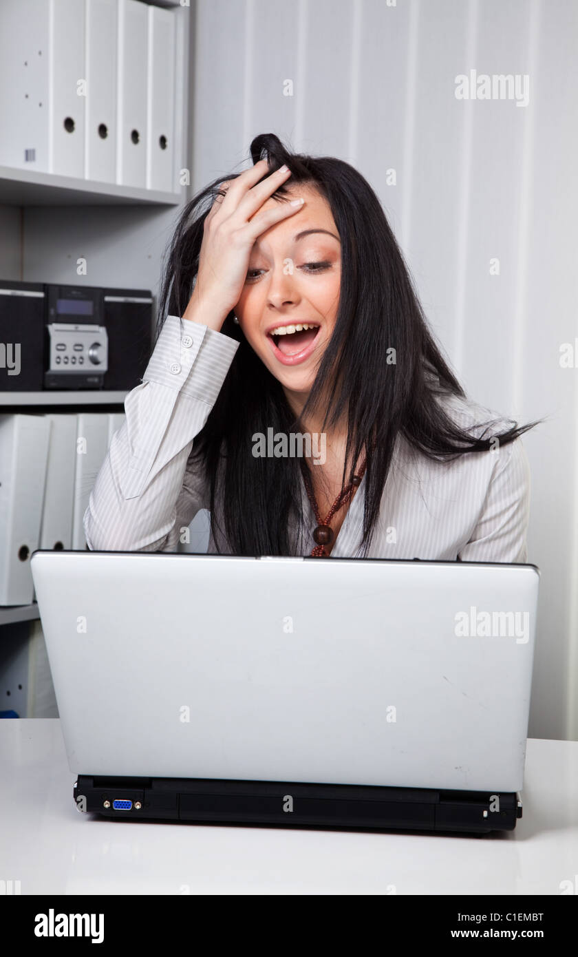 Desperate young woman facing a problem on the laptop Stock Photo - Alamy