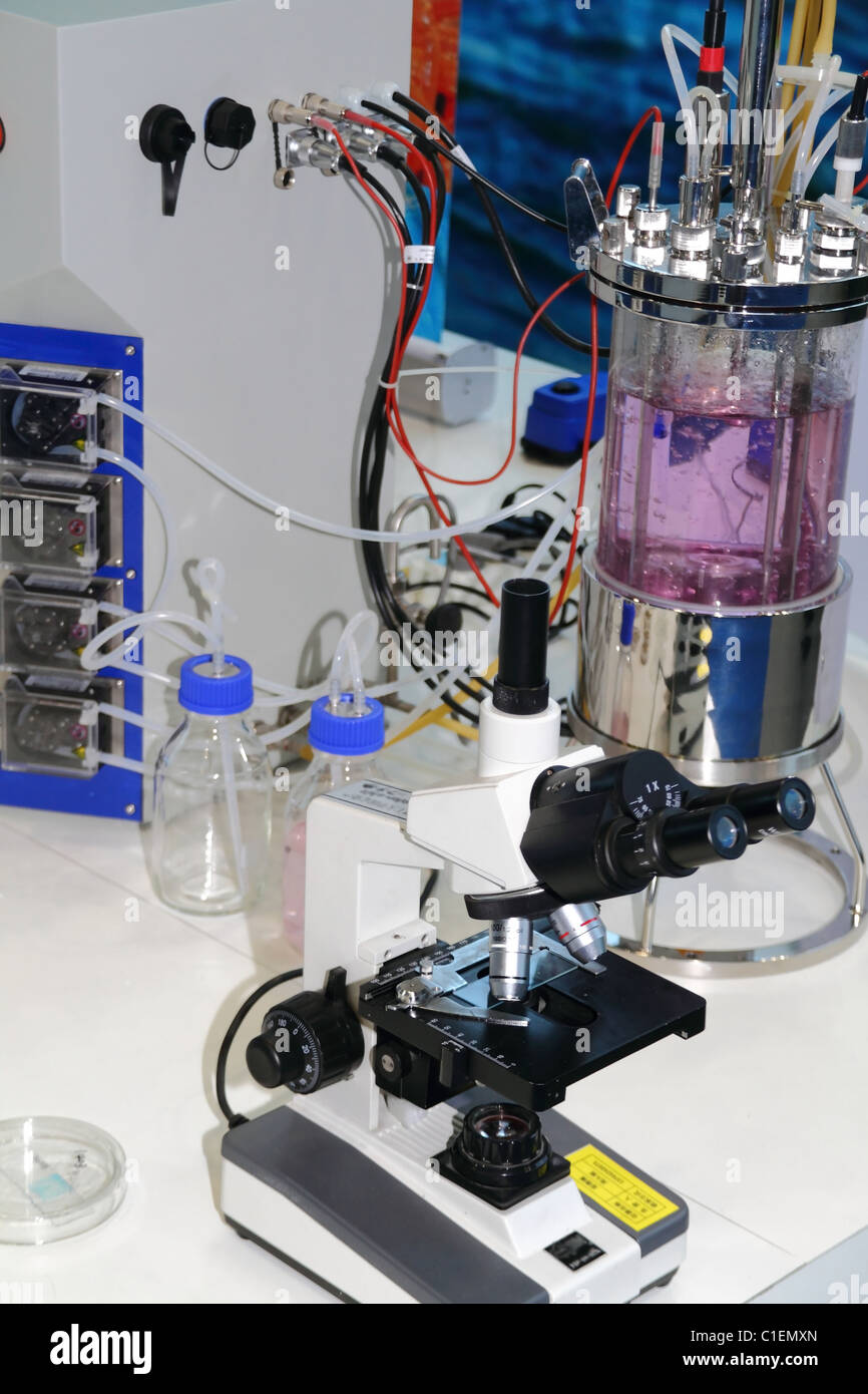 research microscope and laboratory bottles with colored liquid Stock ...