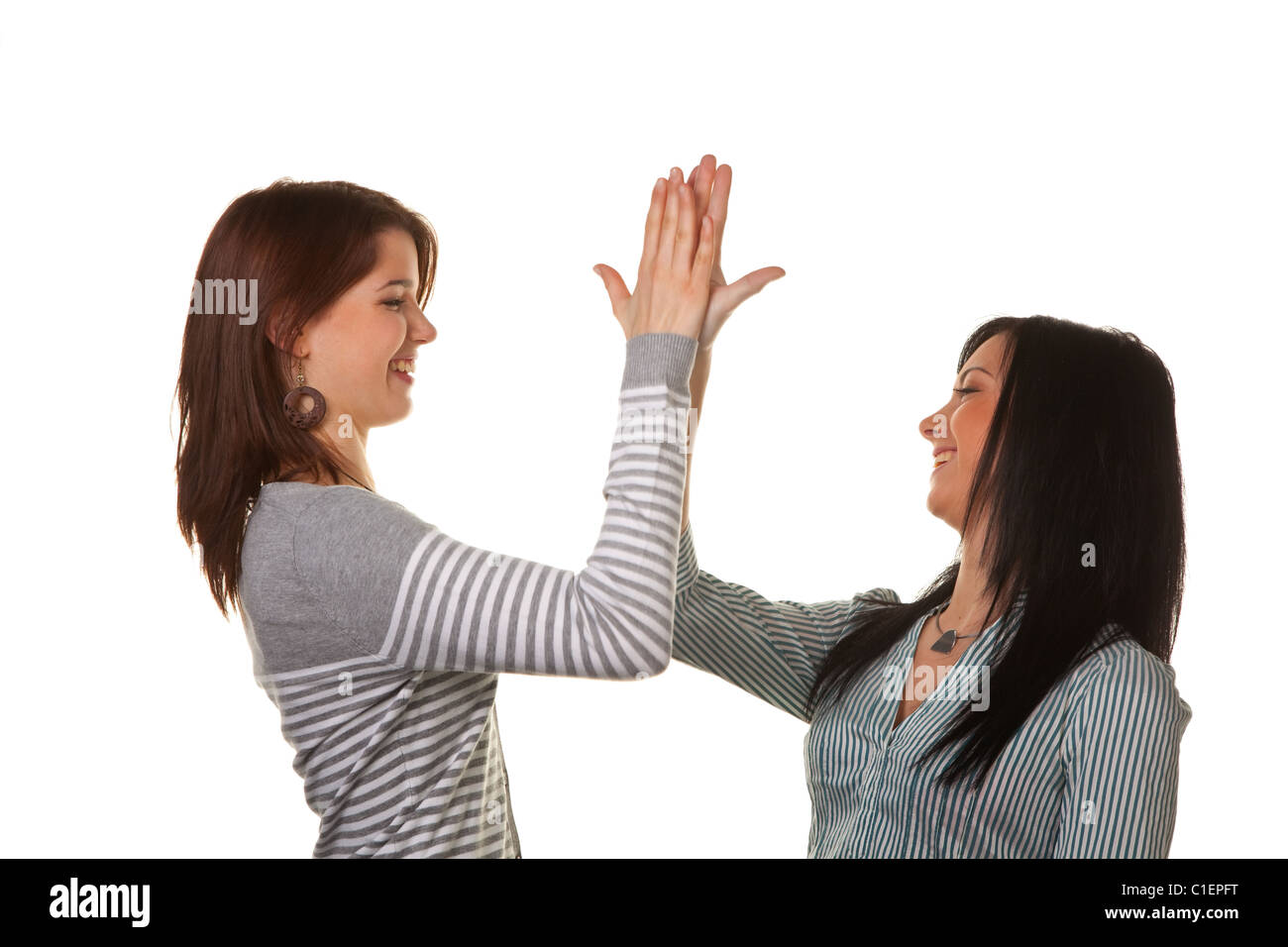 Two young girls handshake and agree Stock Photo - Alamy