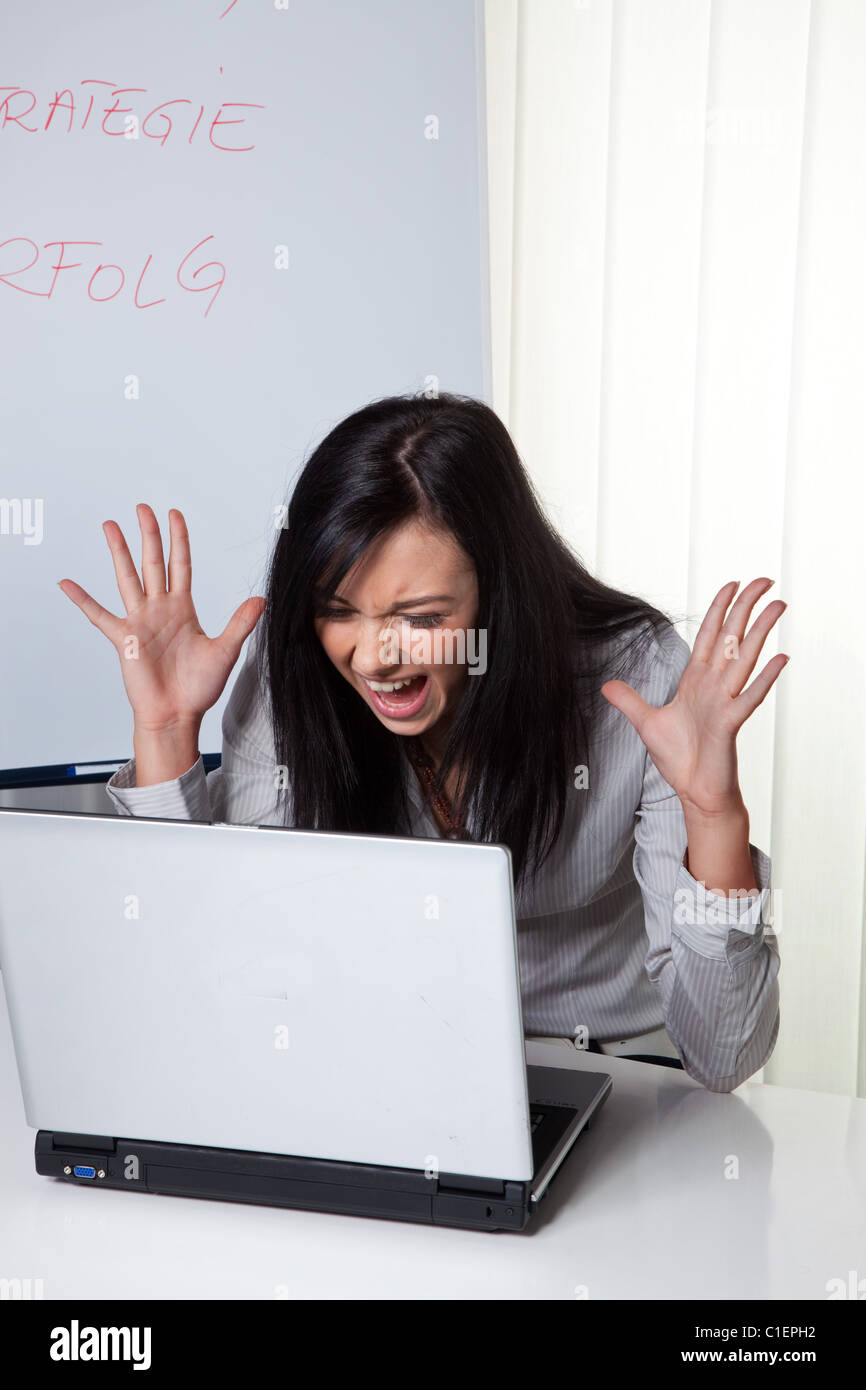 Desperate young woman facing a problem on the laptop Stock Photo - Alamy