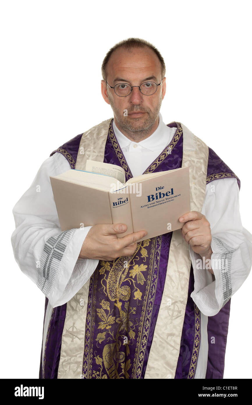 a Catholic priest with bible in worship Stock Photo - Alamy