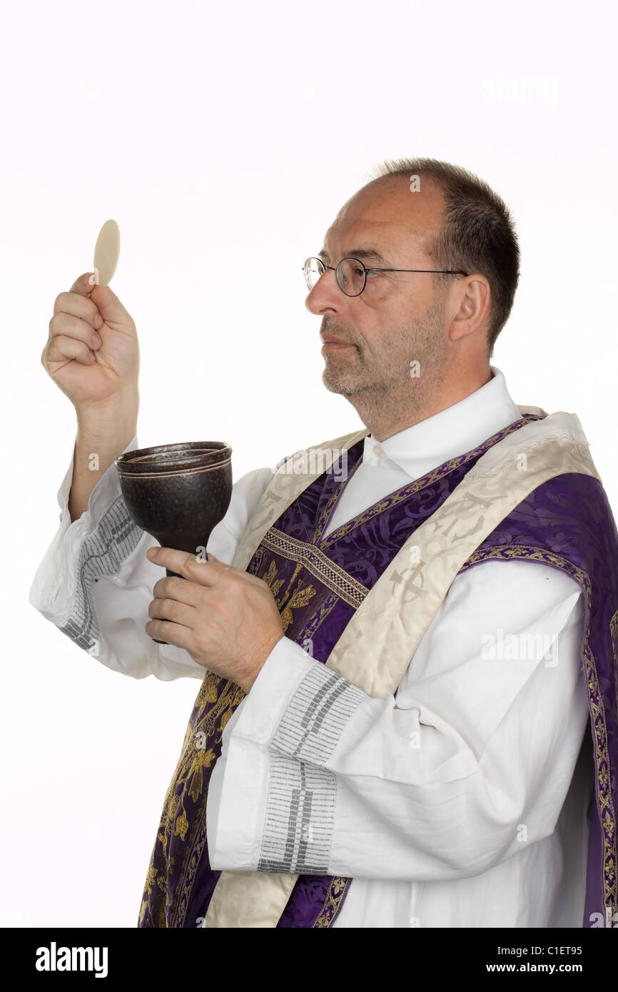 a Catholic priest during communion in worship Stock Photo - Alamy