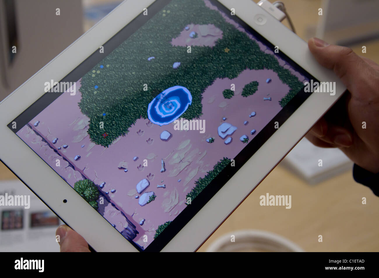 playing game on apple ipad white Stock Photo - Alamy