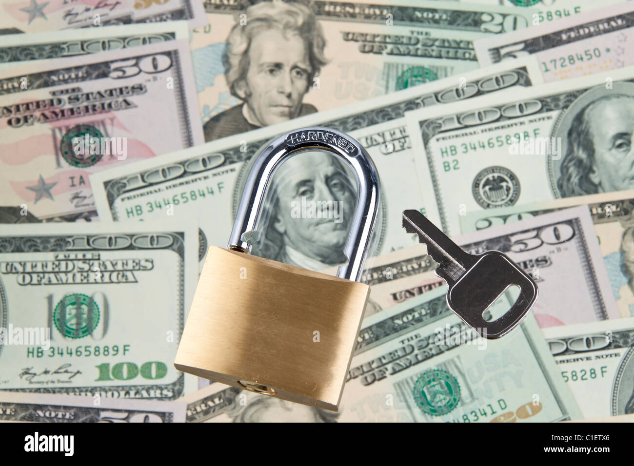 Many dollar bills with lock Stock Photo - Alamy