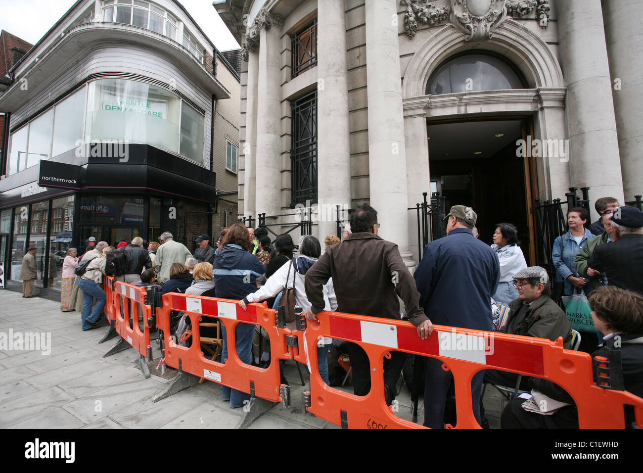 Customers queue outside Northern Rock bank Golders Green branch, London ...