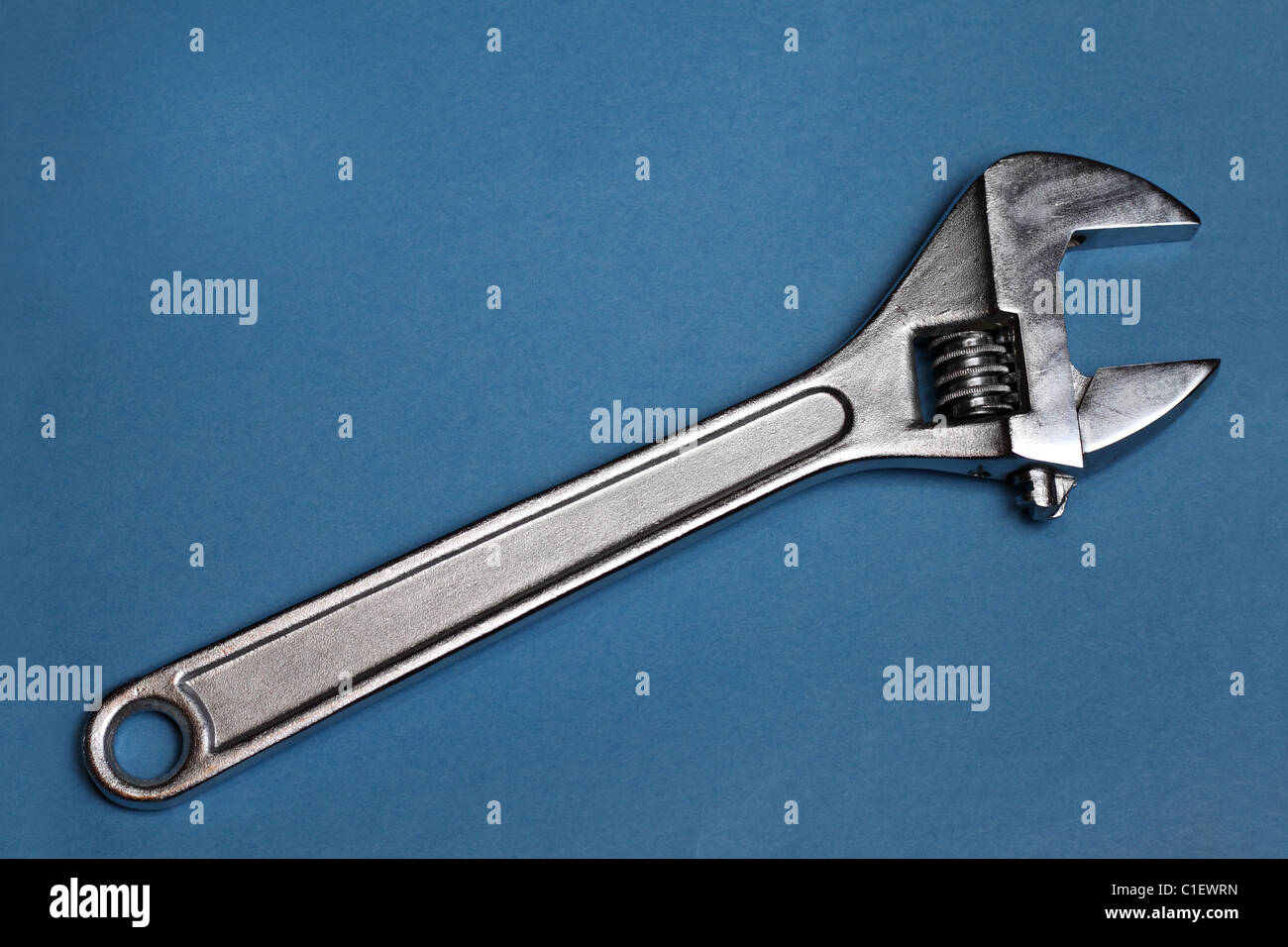 Adjustable steel wrench on blue background Stock Photo - Alamy