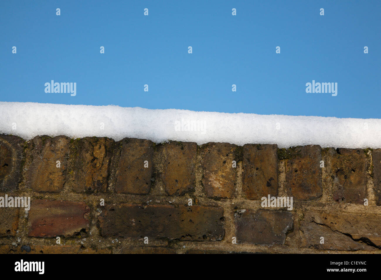 Snow capped brick wall Stock Photo - Alamy