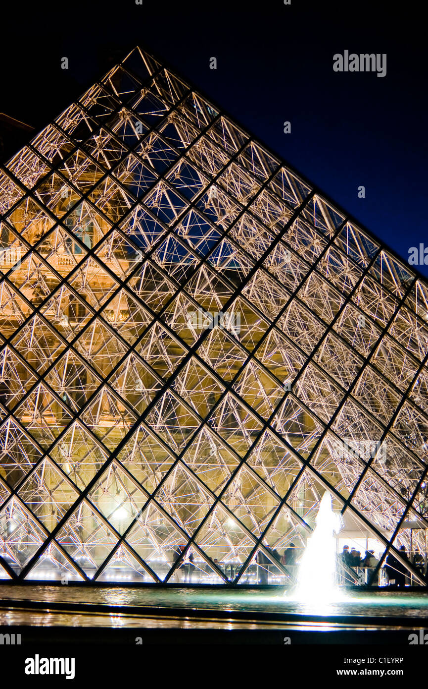 Paris louvre pyramid at night credit hi-res stock photography and ...