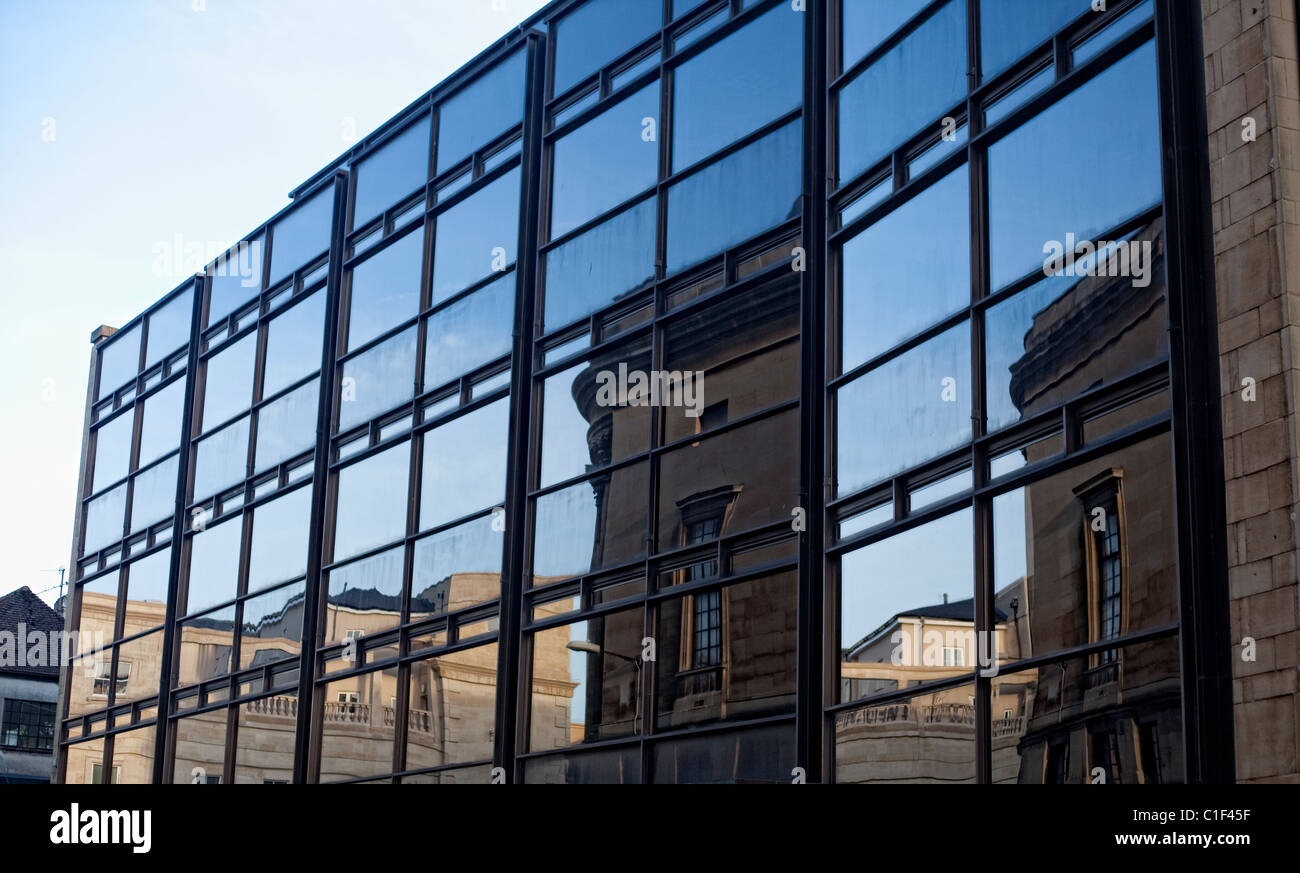 Old buildings reflected in the new modern glass building Stock Photo ...