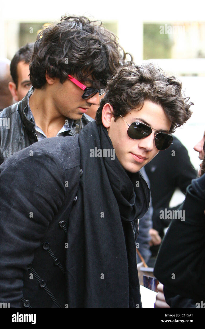 Nick Jonas and Joe Jonas are surrounded by fans outside Radio One ...