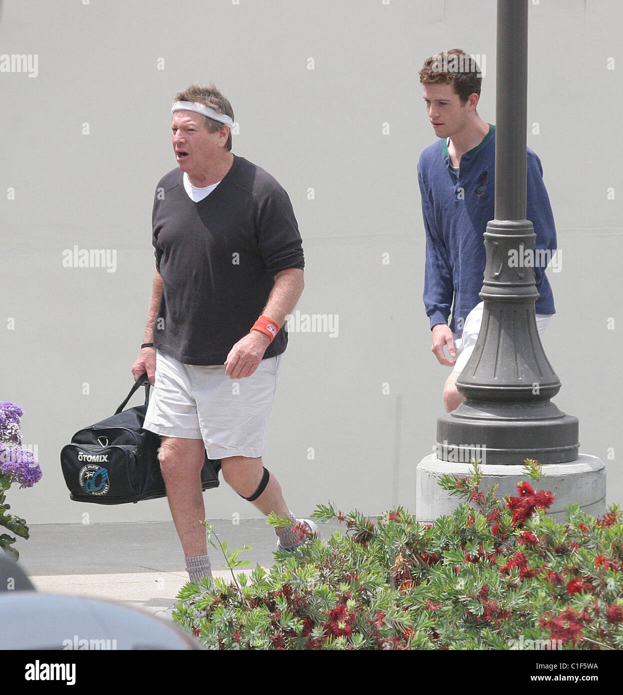 Ryan O'Neal wearing a support bandage on his left leg arrives in good ...
