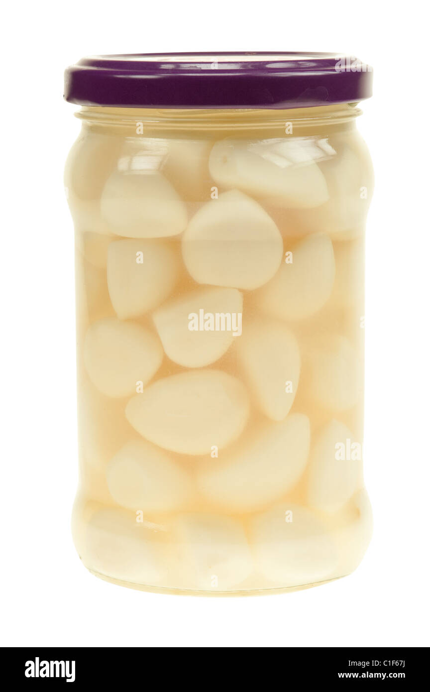 A jar of garlic pieces isolated on a white background Stock Photo - Alamy