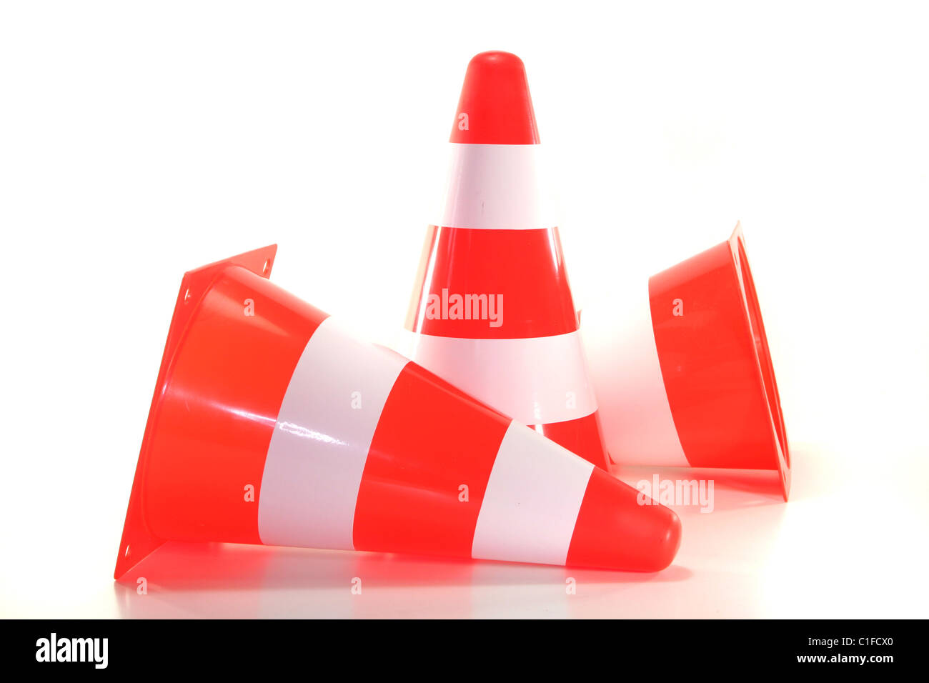 three red and white construction pylons before a white background Stock ...
