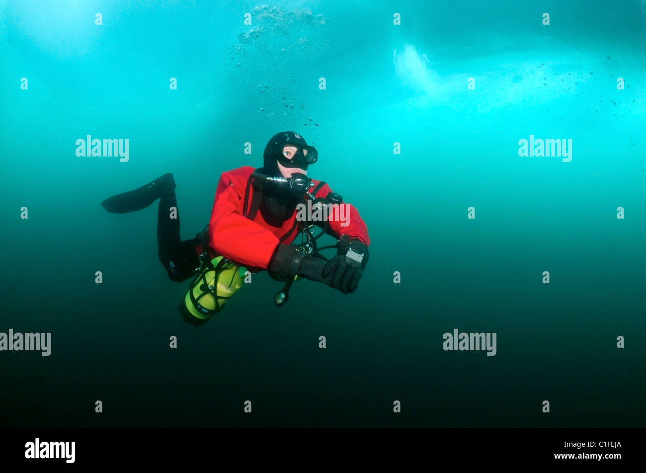 Scuba diver with sidemount under ice, in lake Baikal, Siberia, Russia ...