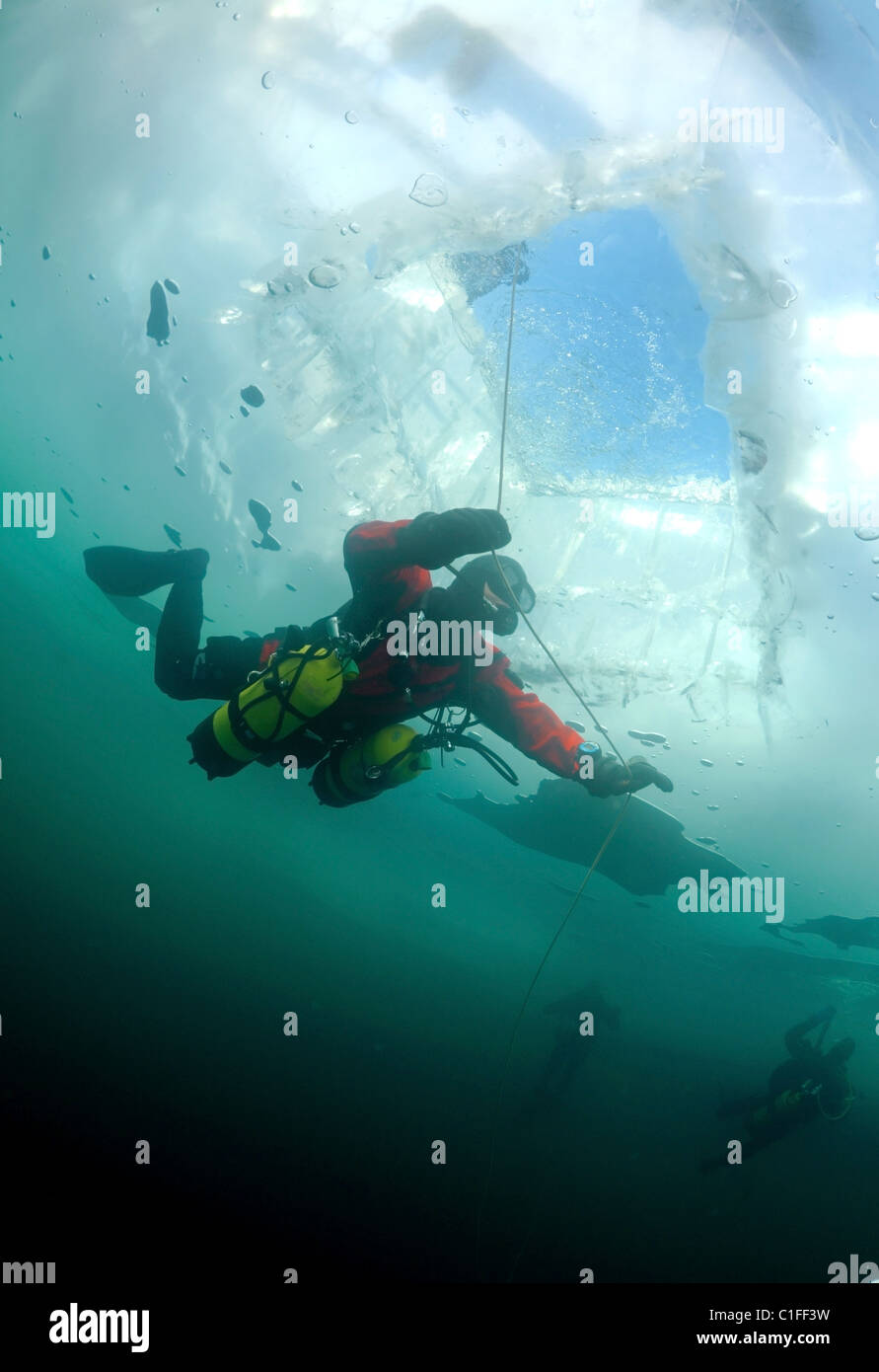 Scuba diver with sidemount under ice, in lake Baikal, Siberia, Russia ...