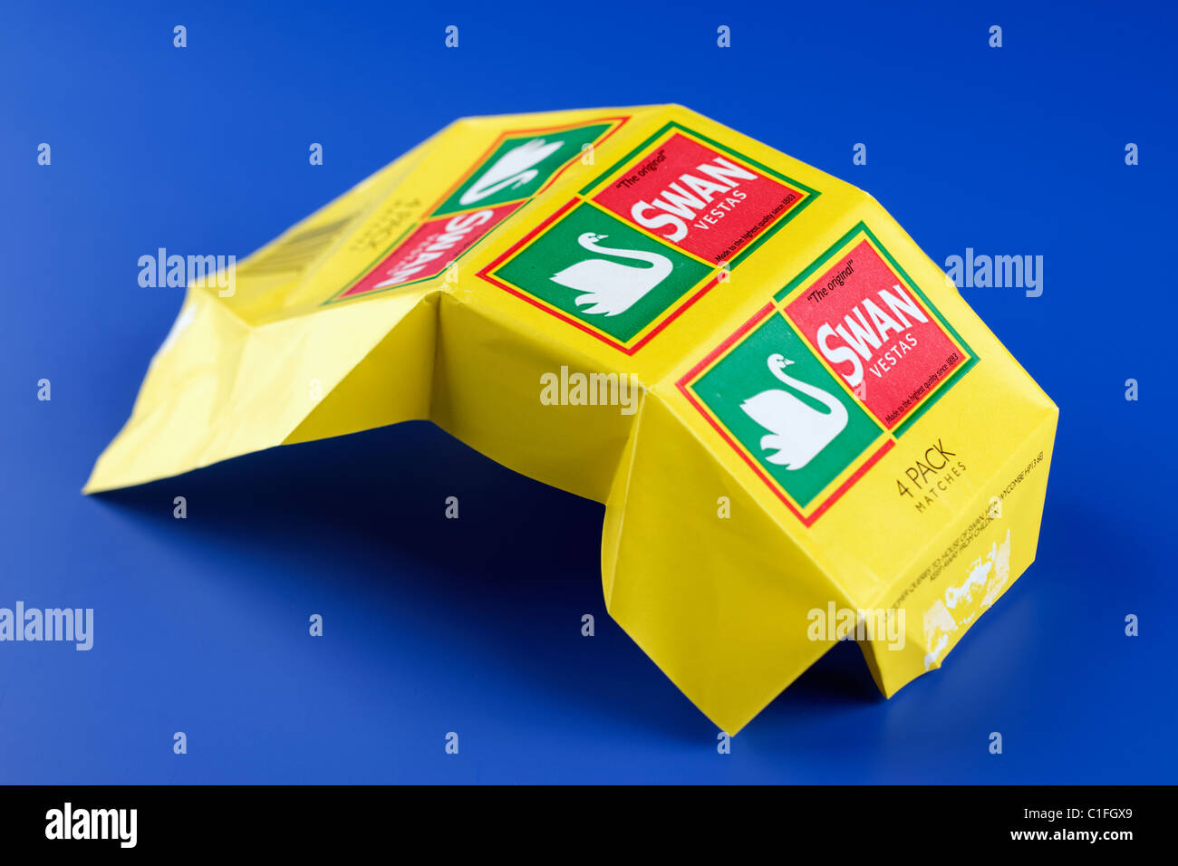Yellow wrapper on a blue background Stock Photo - Alamy