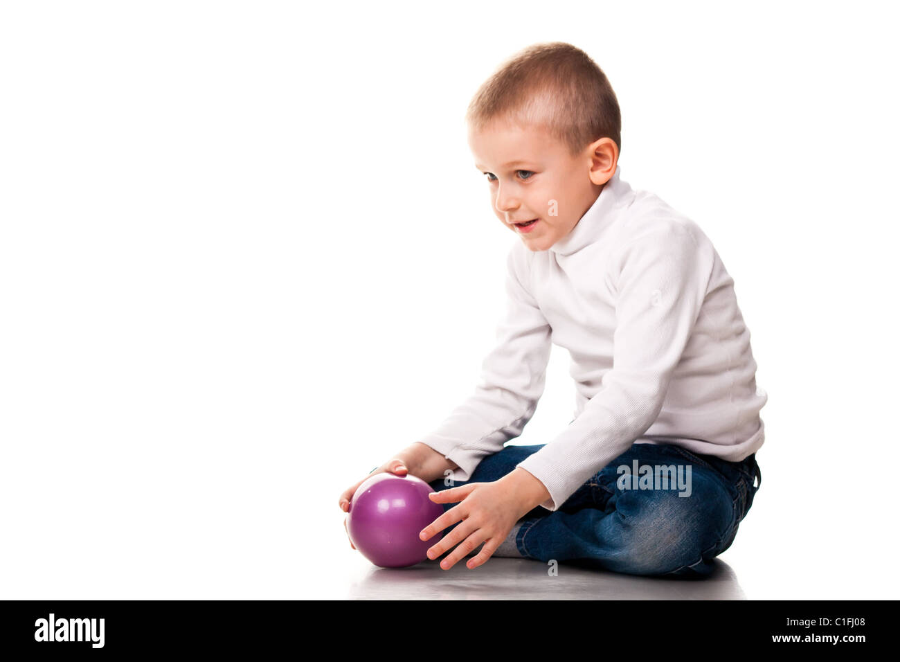 Cute little boy playing with a ball isolated on white Stock Photo - Alamy