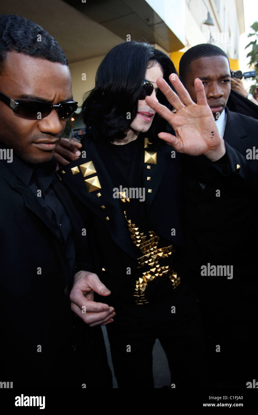 Michael Jackson is flanked by security as he leaves Tom's Toys after ...