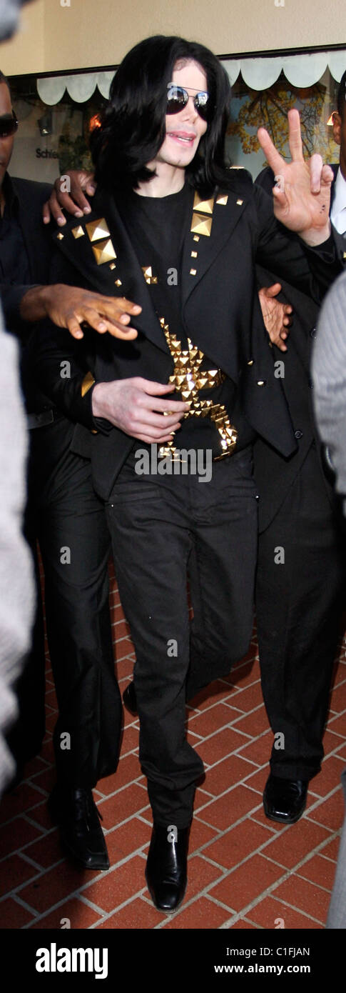 Michael Jackson is flanked by security as he leaves Tom's Toys after ...