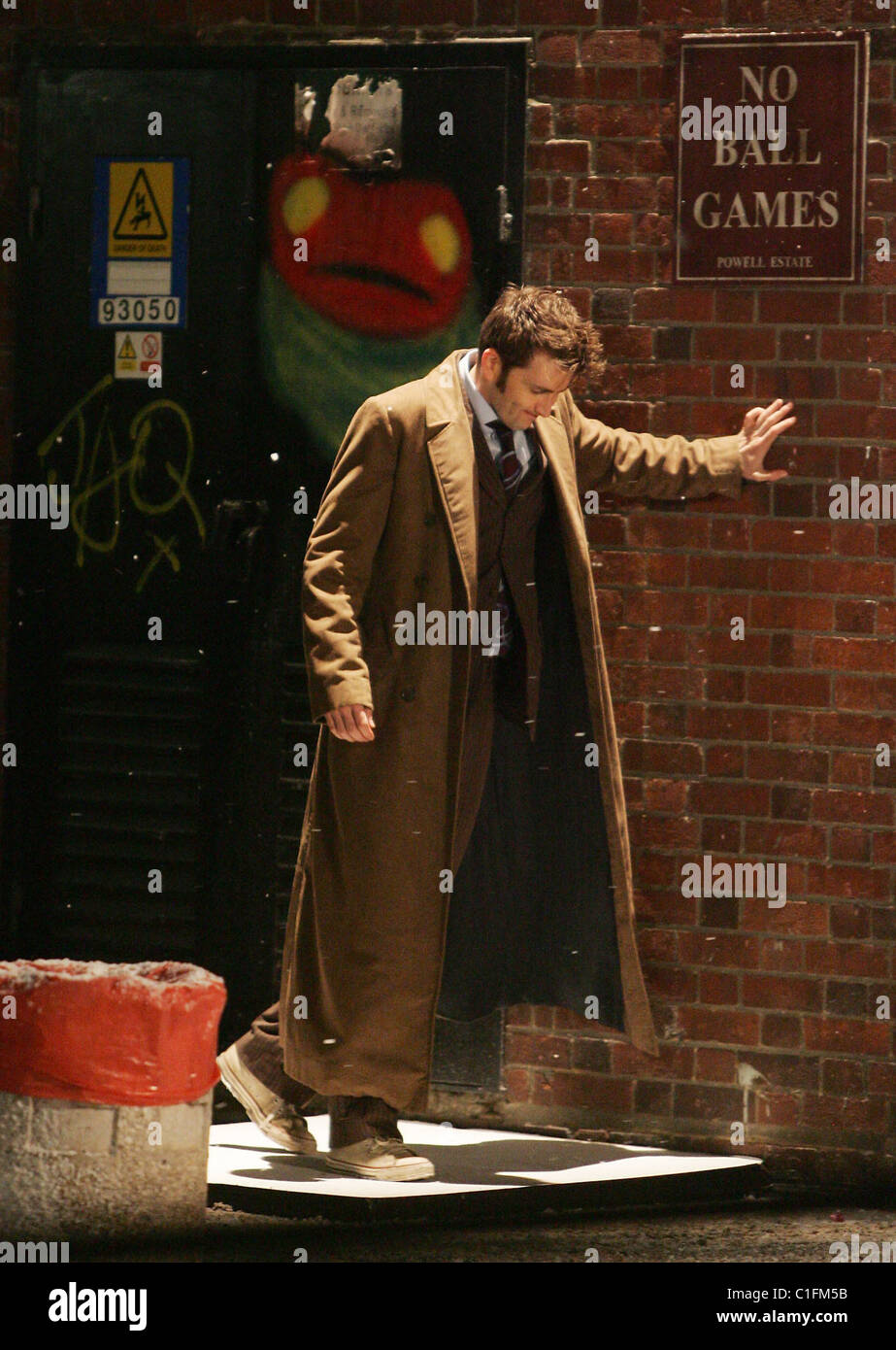 David Tennant looks in distress as he leans against a wall whilst ...