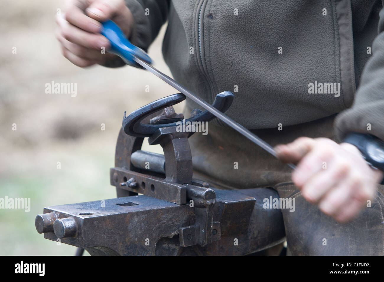 Farrier filing new horseshoe prior to fitting Stock Photo - Alamy