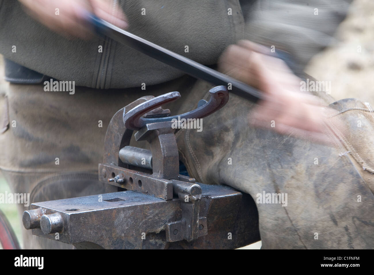 Farrier filing new horseshoe prior to fitting Stock Photo - Alamy