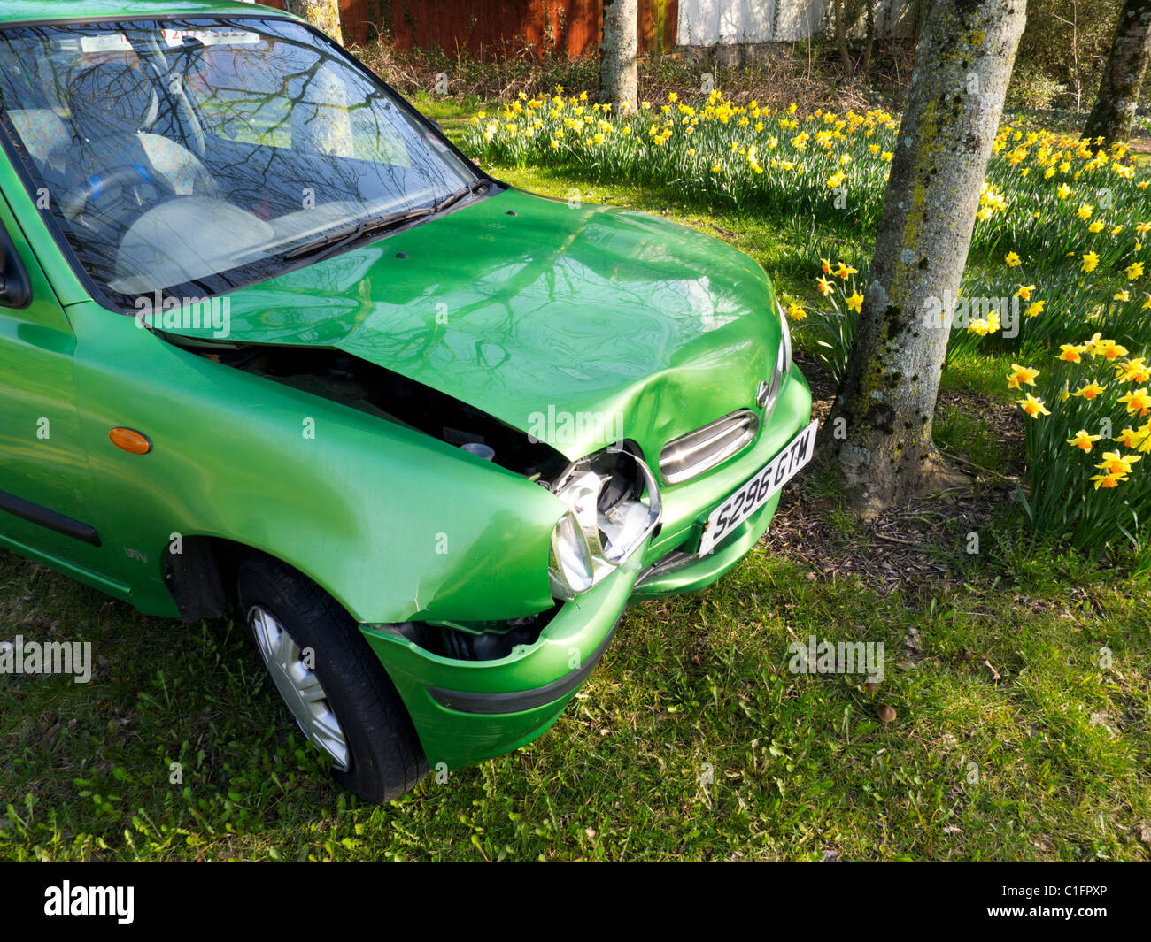Small green Nissan Micra car after frontal crash into tree on rural ...