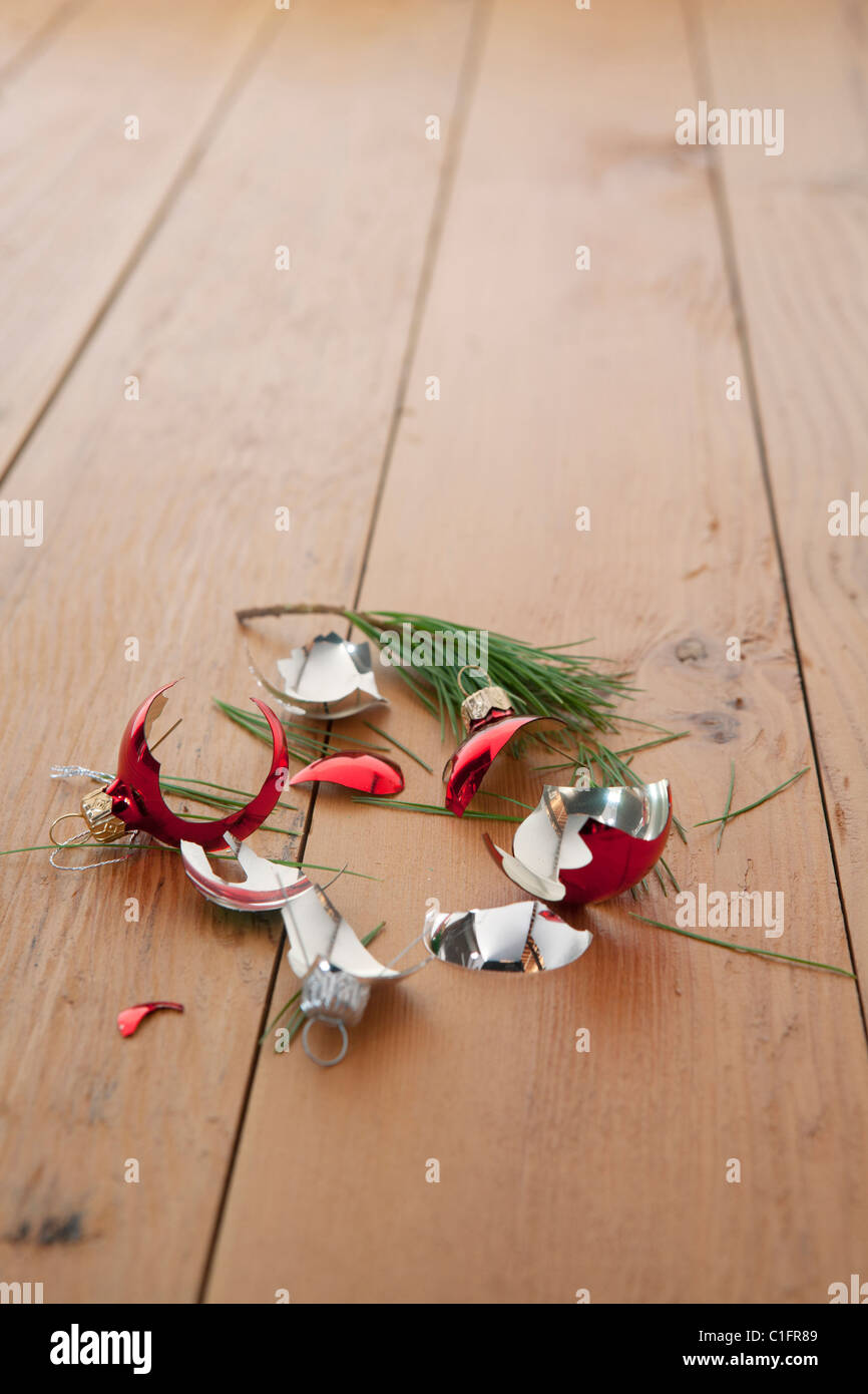 Broken Christmas ornament on floor Stock Photo - Alamy