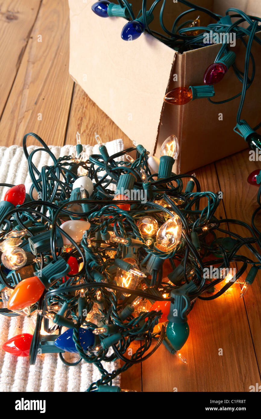 Glowing Christmas lights tangled on floor Stock Photo - Alamy
