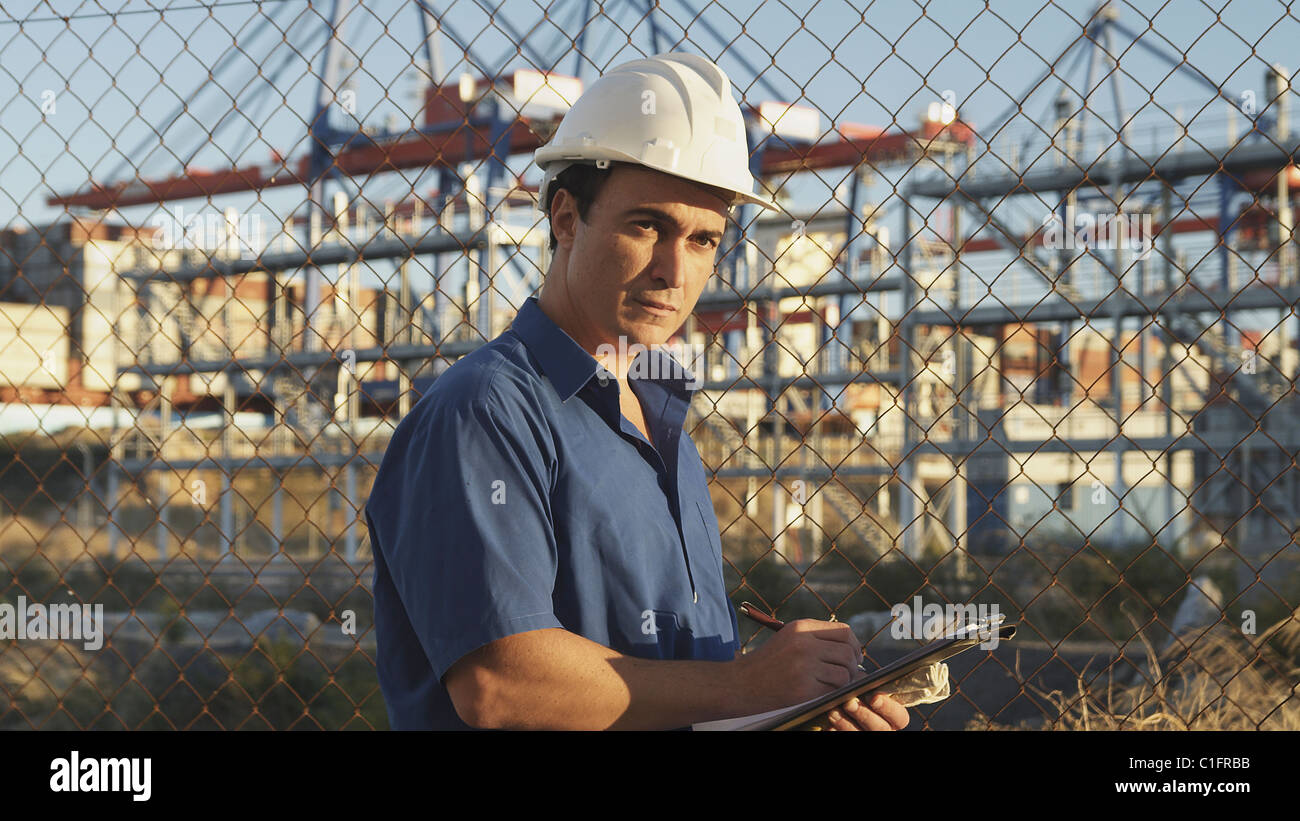 Hispanic man with clipboard on construction site Stock Photo - Alamy