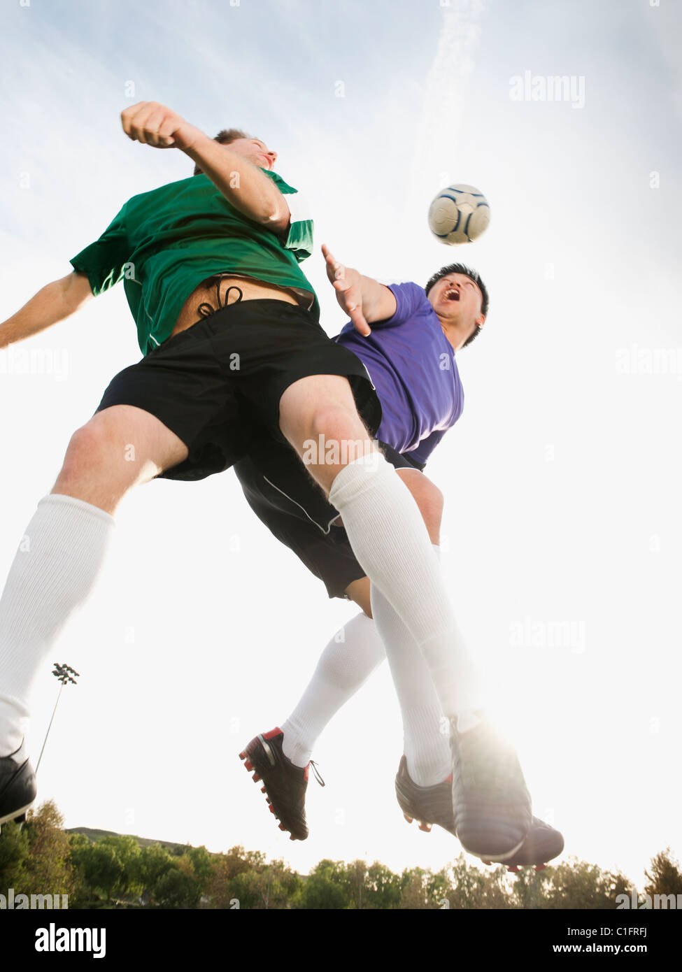 Soccer players heading soccer ball Stock Photo - Alamy