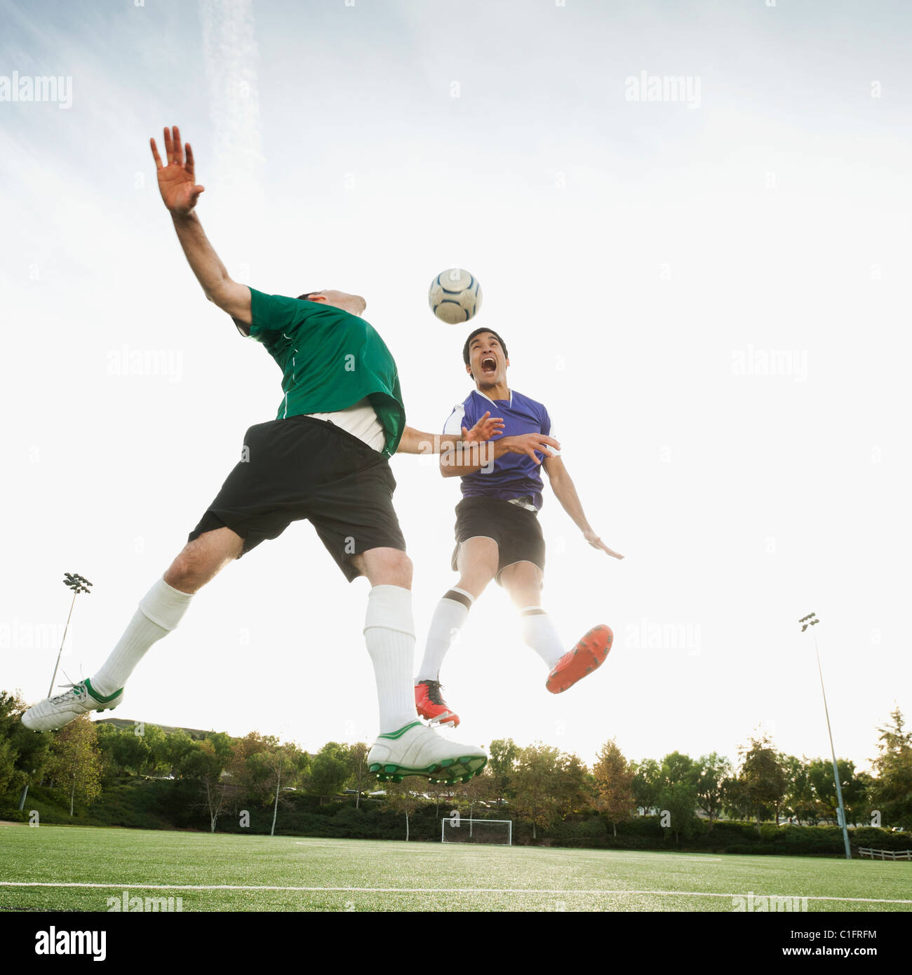 Soccer players heading soccer ball Stock Photo - Alamy